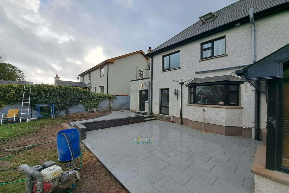 Patio with Silver Granite Slabs, Charcoal Border and Connemara Walling ...